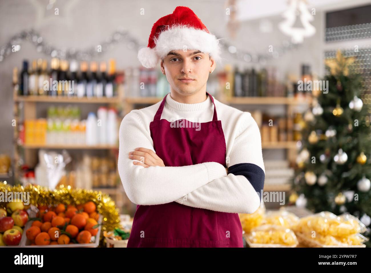 Young guy seller posing in grocery store Stock Photo - Alamy