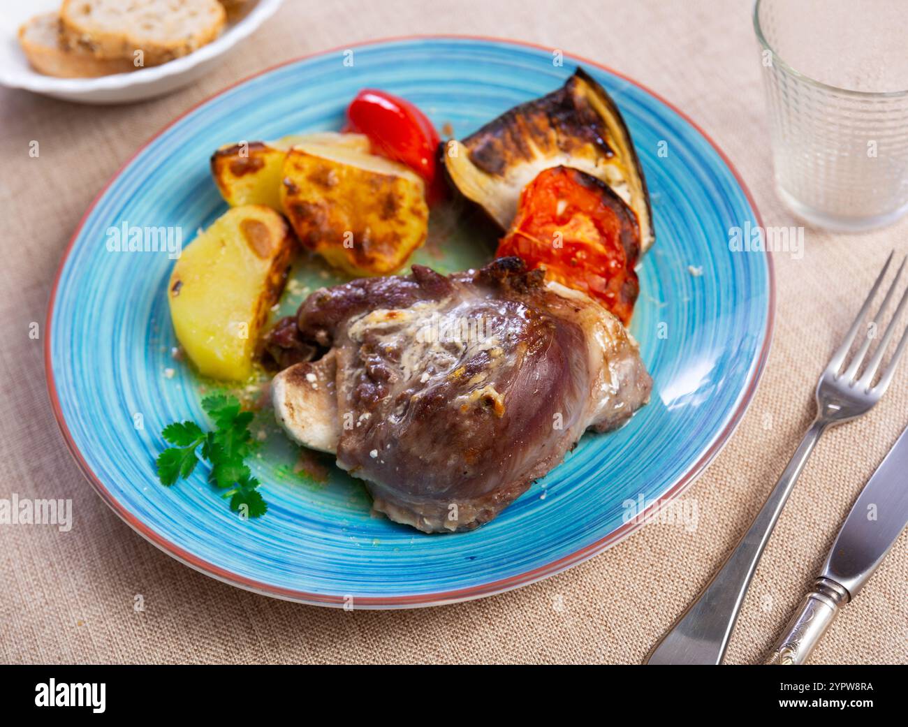 Baked pork cheek served with vegetables Stock Photo - Alamy
