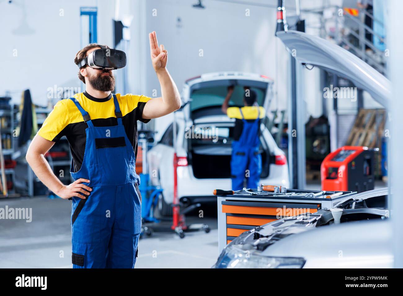 Professional in auto repair shop uses virtual reality to visualize car ...