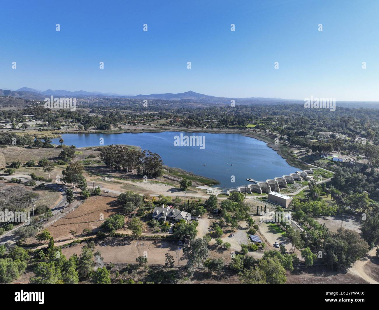 Aerial view over water reservoir and a large dam that holds water ...