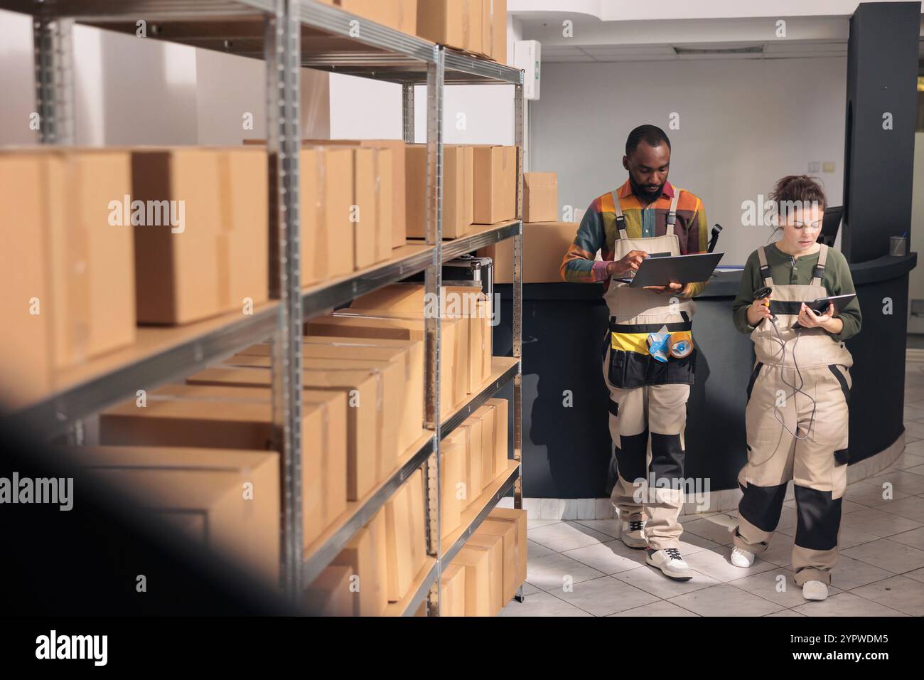 Warehouse employee checking goods logistics on device, shipping and ...
