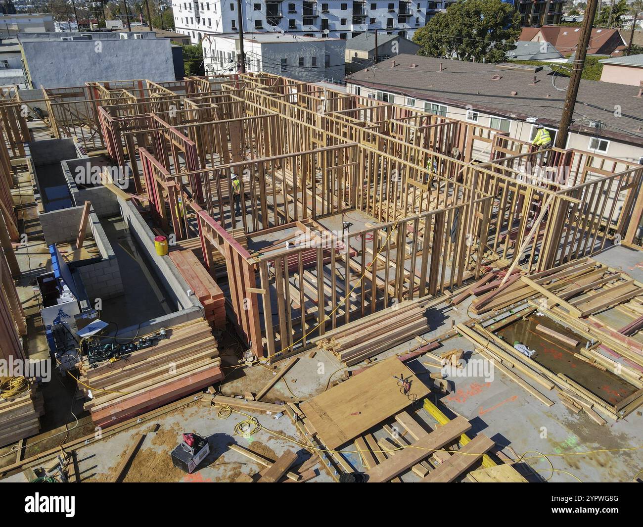 Aerial view of a new building being framed by carpenters. Worker ...