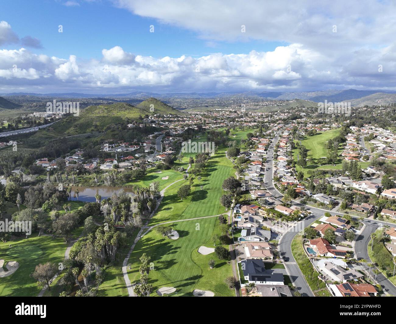 Aerial view of residential neighborhood surrounded by golf and valley ...