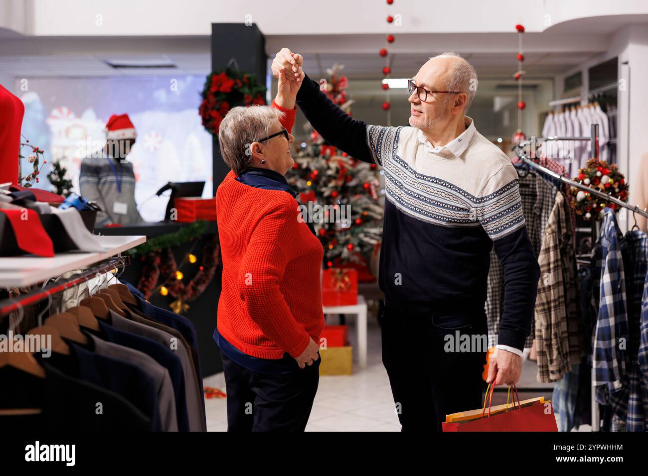 Sweet couple dancing in clothing store, moving around ambience music ...
