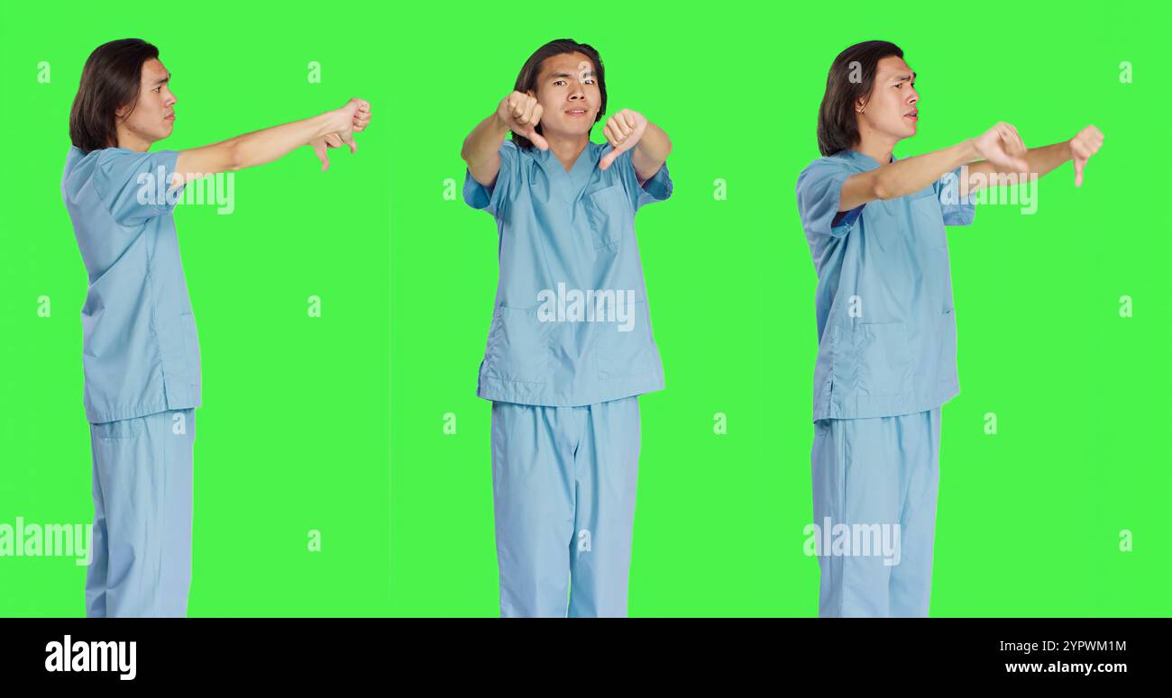 Asian specialist showing thumbs down symbol in studio, giving dislike ...