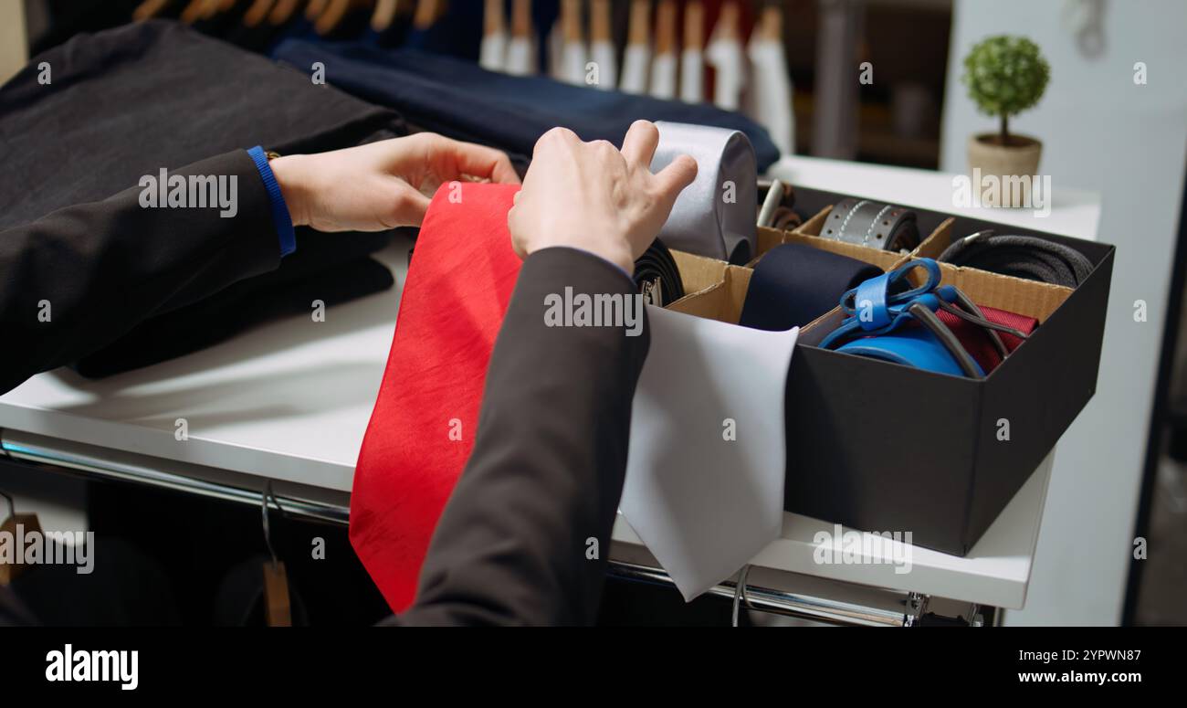 Employee arranging ties accessories hi-res stock photography and images ...