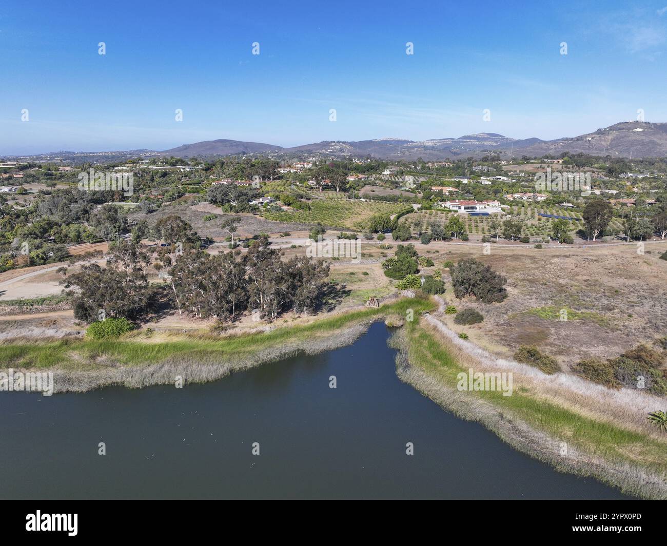 Aerial view over water reservoir and a large dam that holds water ...