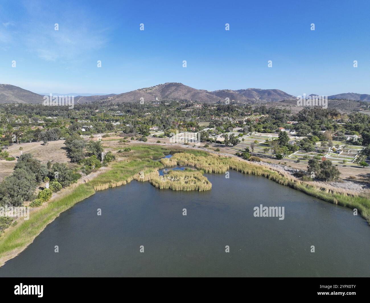 Aerial view over water reservoir and a large dam that holds water ...