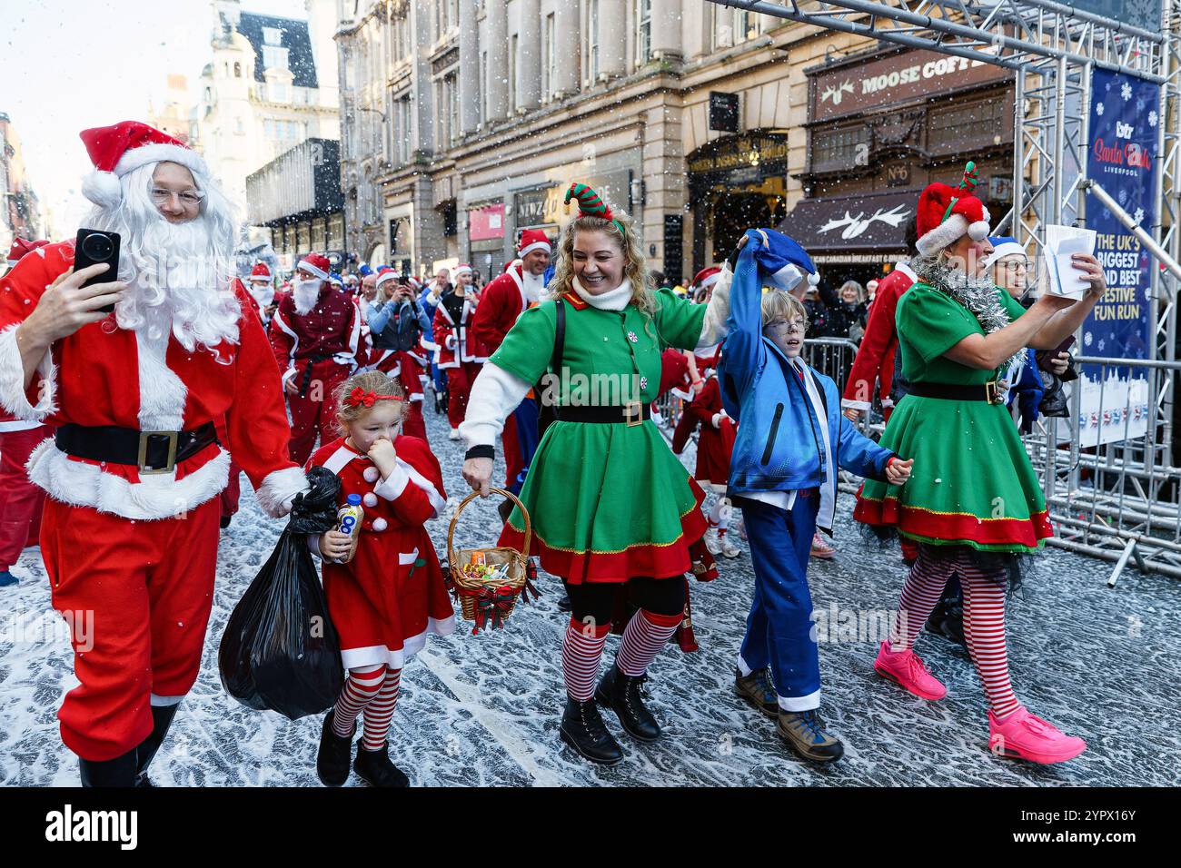 Runners in fancy dresses take part during the Liverpool Santa Dash 2024 ...