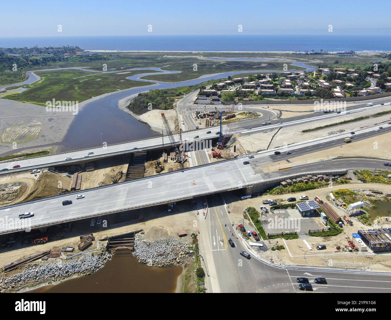 Aerial view of highway bridge construction over small river, San Diego ...
