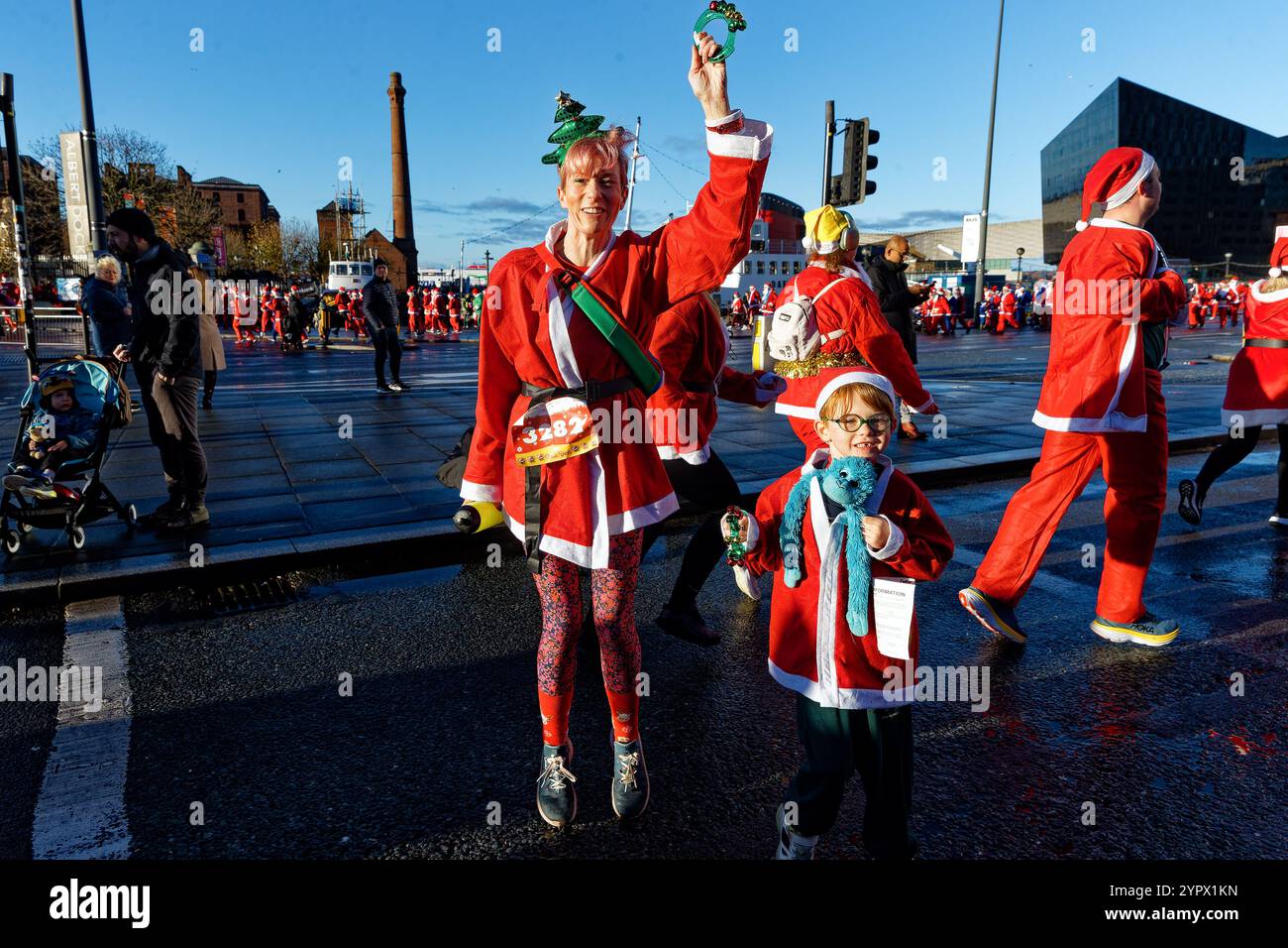 Two happy runners seen during the Liverpool Santa Dash. Participants ...
