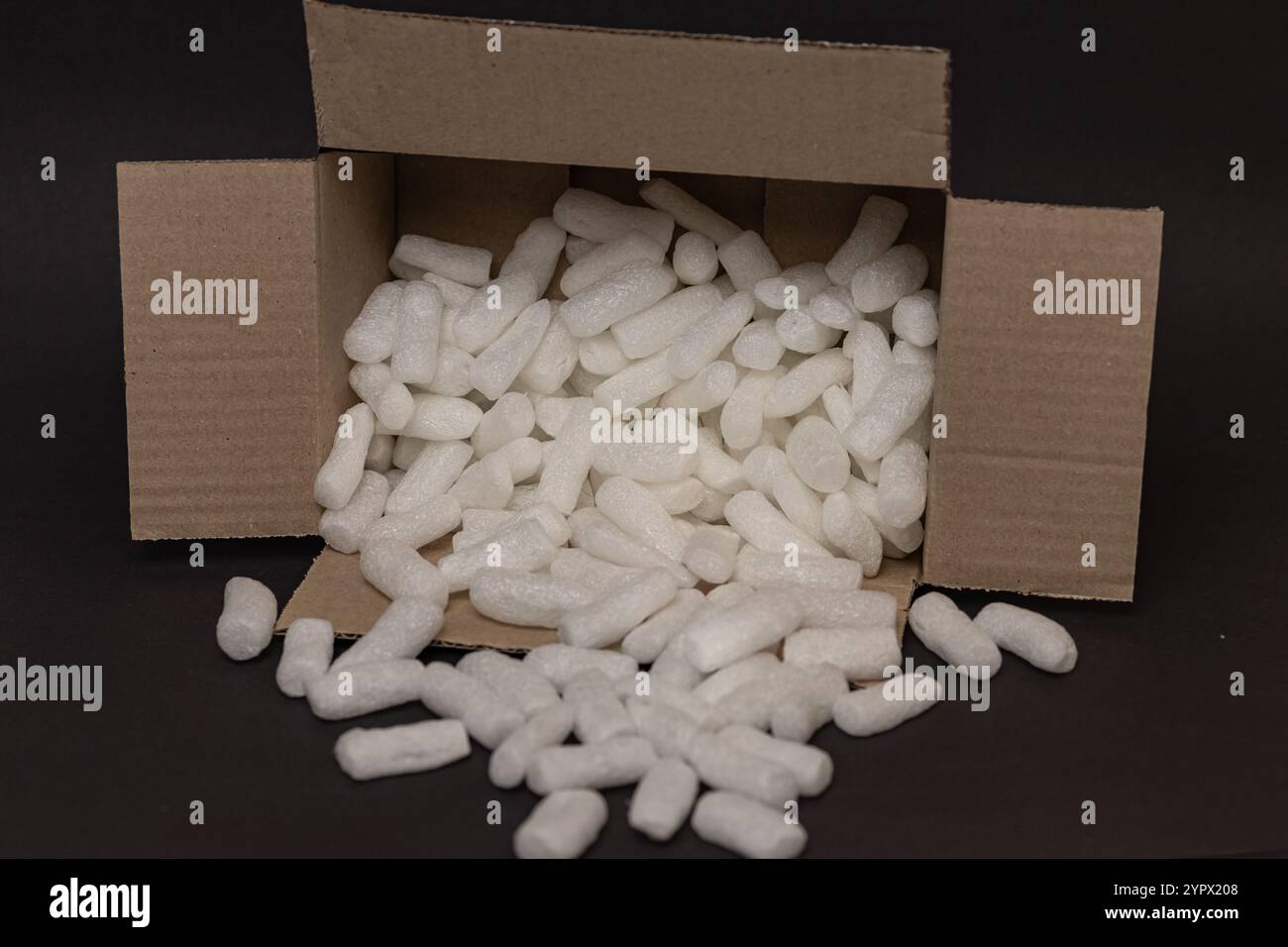 Open cardboard box with white polystyrene foam peanuts spilling ...