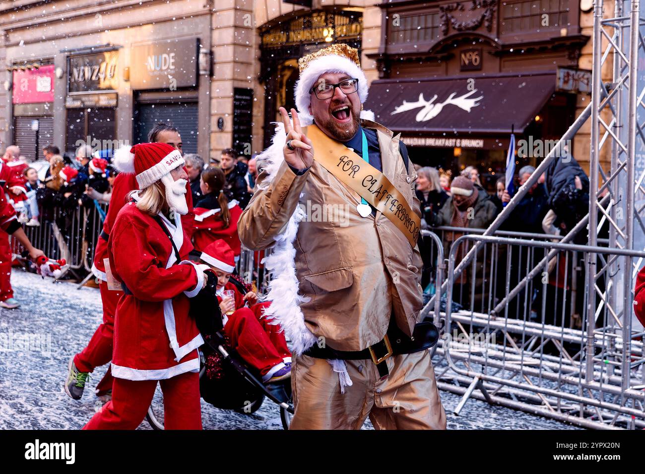 Happy runners approach the finishing line during the Liverpool Santa ...