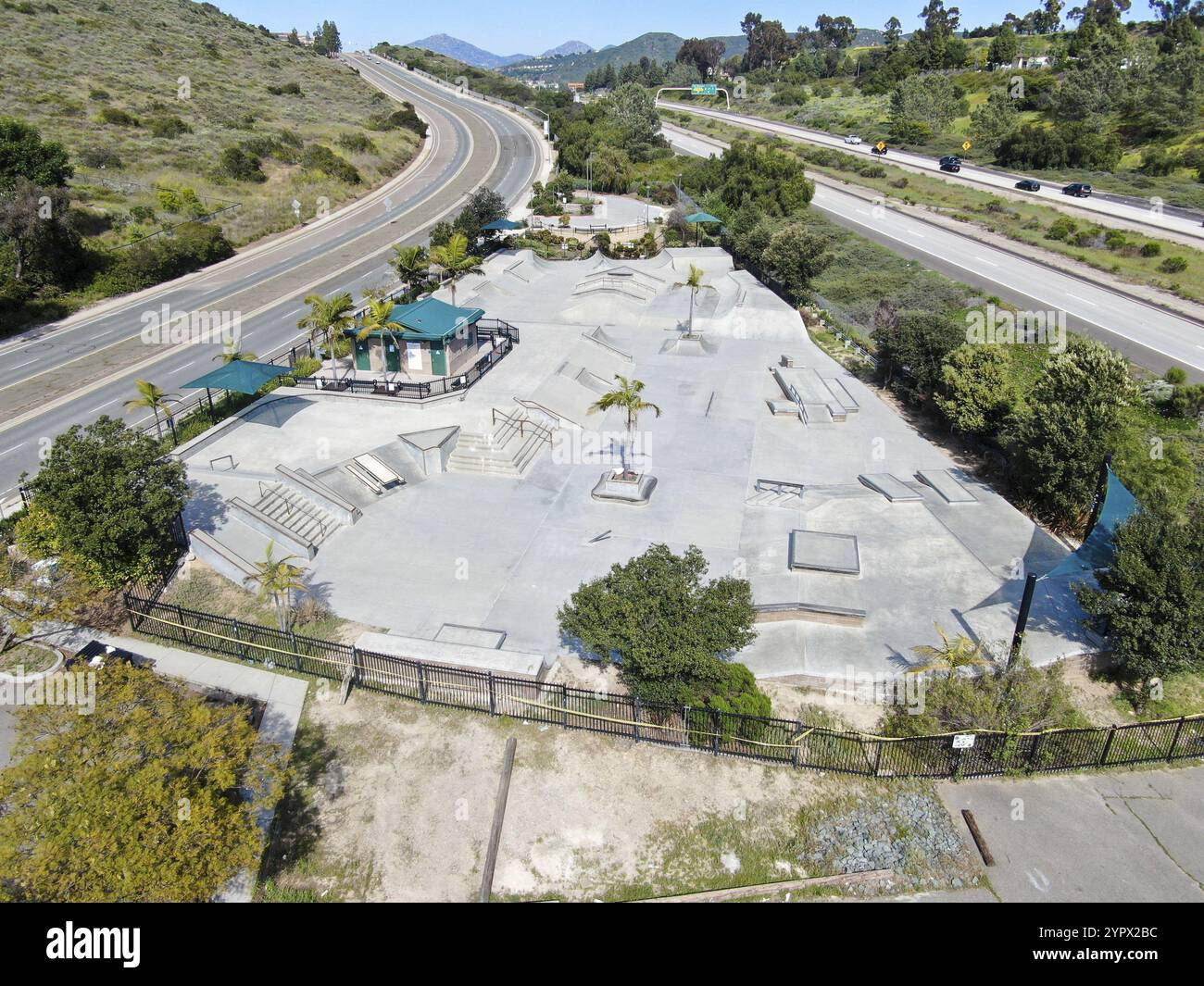 Aerial view of outdoor empty concrete skate park with ramps and pipes ...