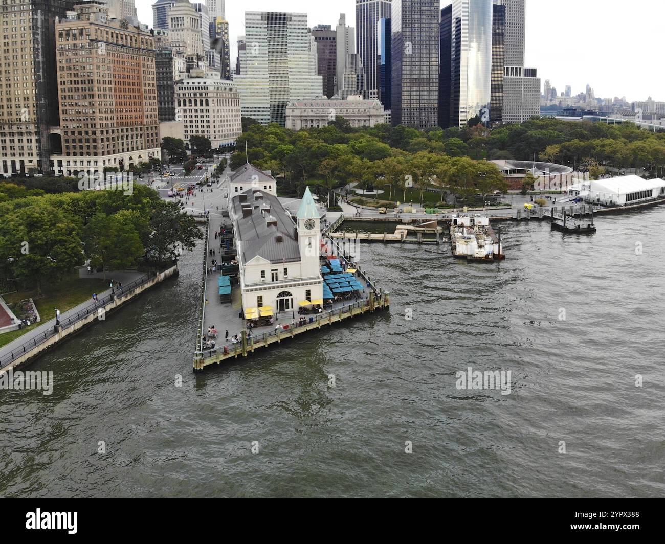 Aerial view of Battery Park pier A leading to Liberty Island, people ...