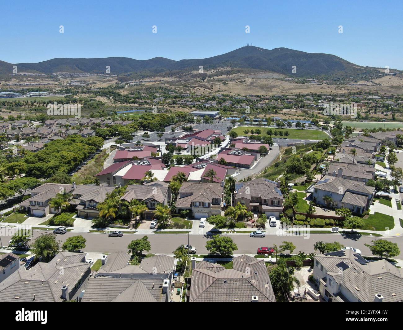 Aerial view of suburban neighborhood with big mansions and mountain on ...