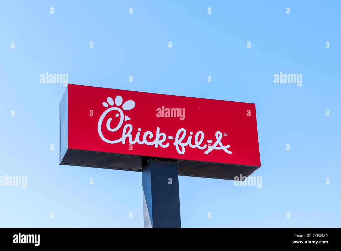 Close up of the Chick-fil-A logo sign with the blue sky in the ...
