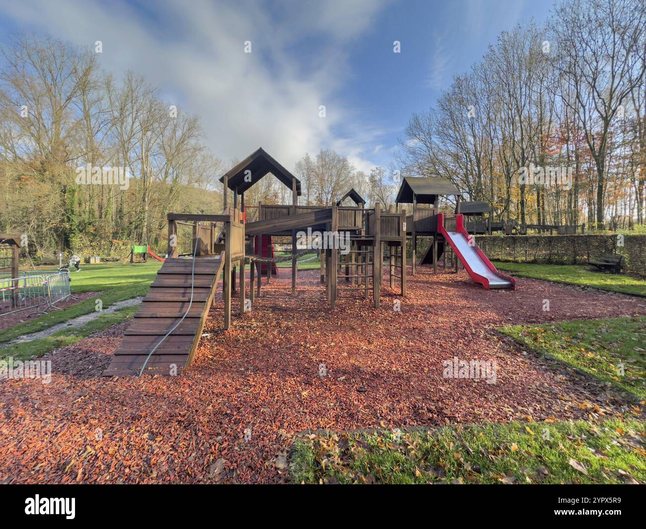 Colorful playground with climbing stairs and slides on yard in the park ...