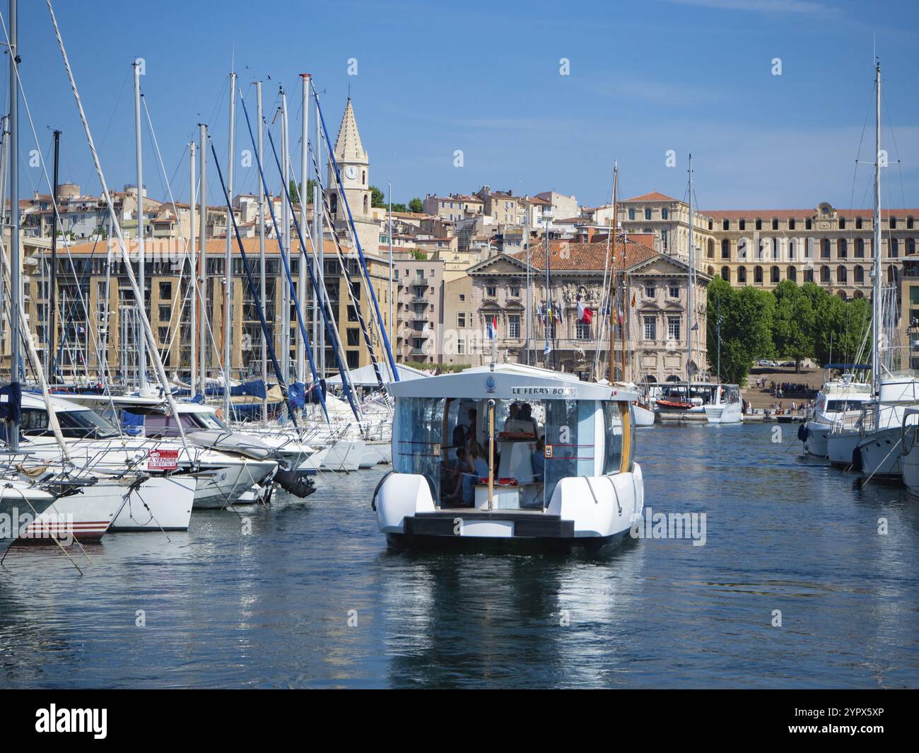 A modern solar powered pedestrian ferry crosses the old harbour in ...
