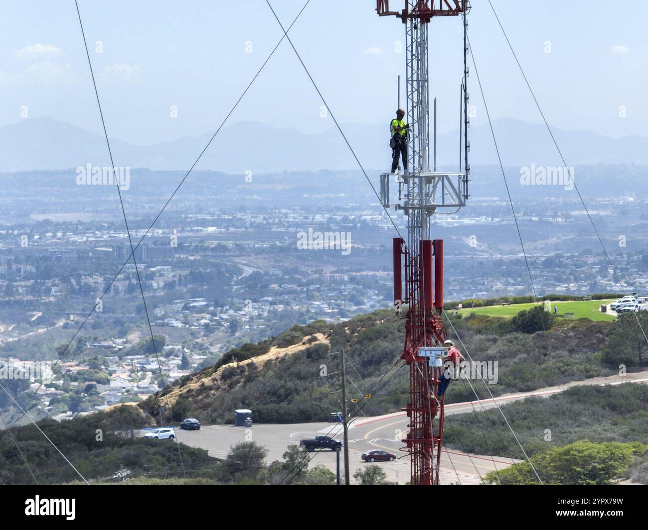 Engineer with safety equipment on high tower for working telecom ...