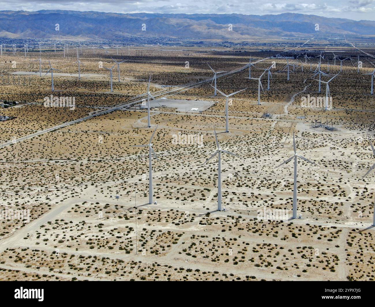 Aerial view of huge array of gigantic wind turbines spreading over the ...