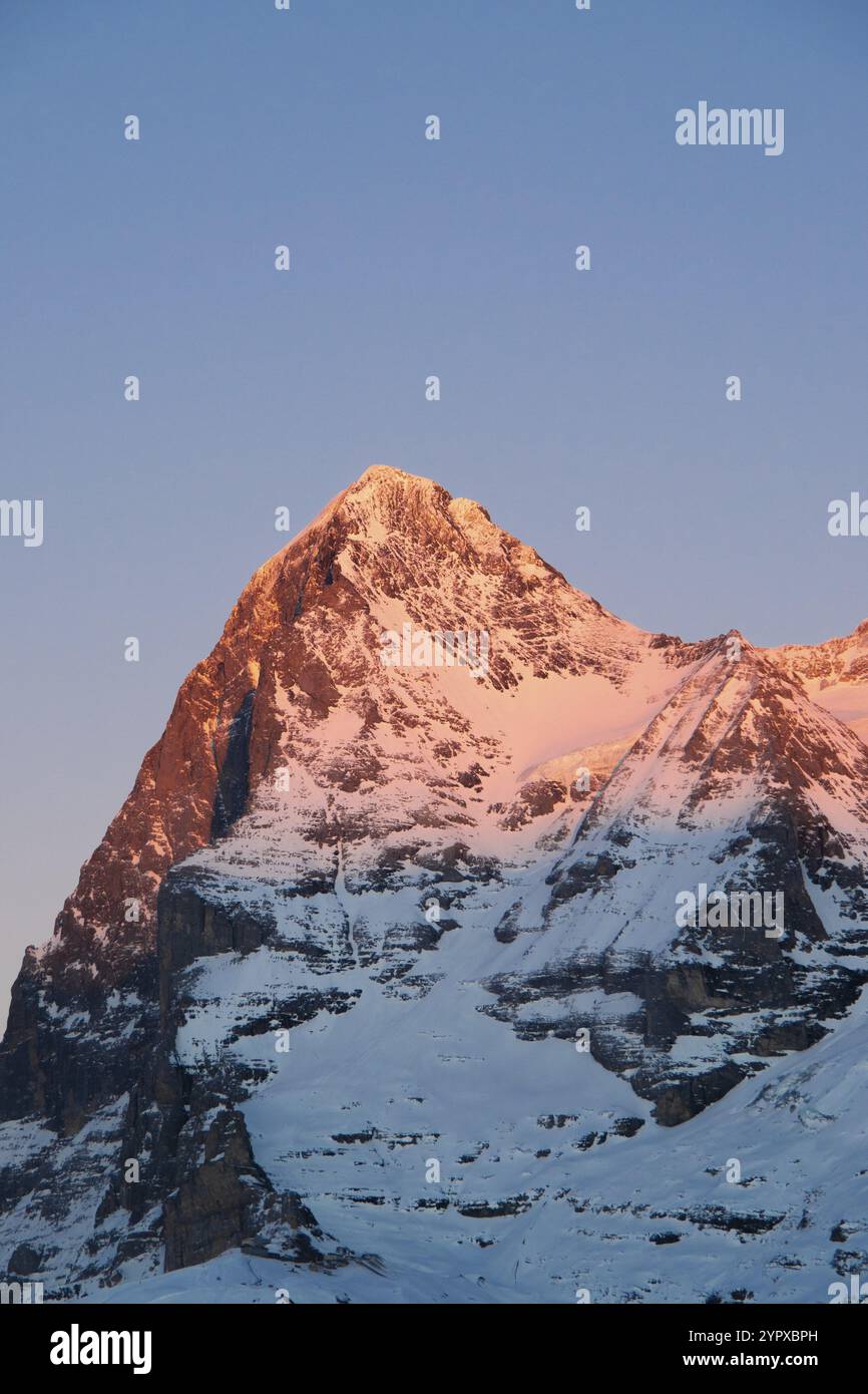 The famous Swiss mountain Eiger in the orange late afternoon winter ...
