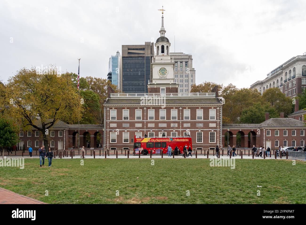 A sightseeing bus and visitors in front of Independence Hall at ...