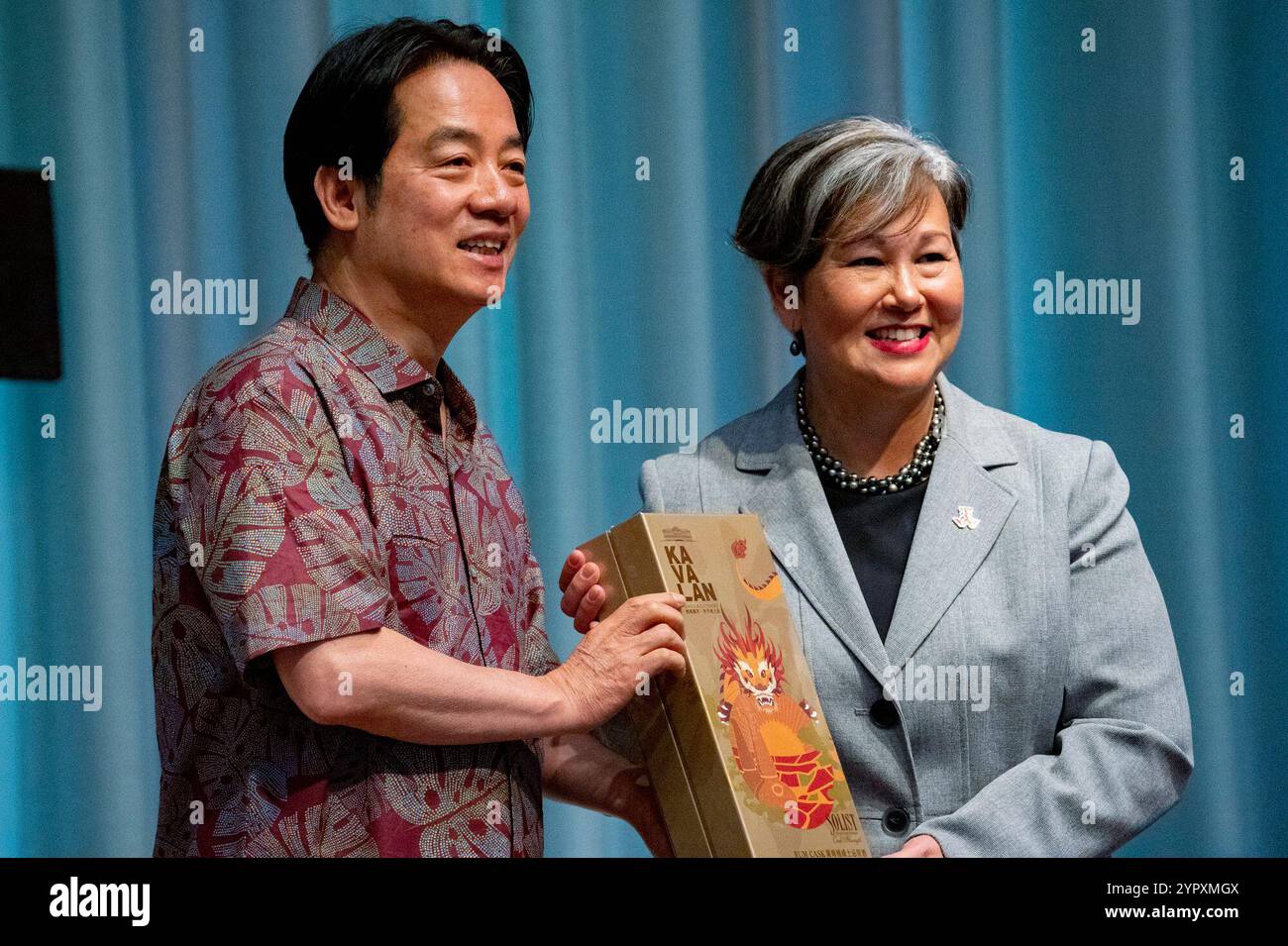 Taiwanese President Lai Ching-te, left, presents a gift to East-West ...