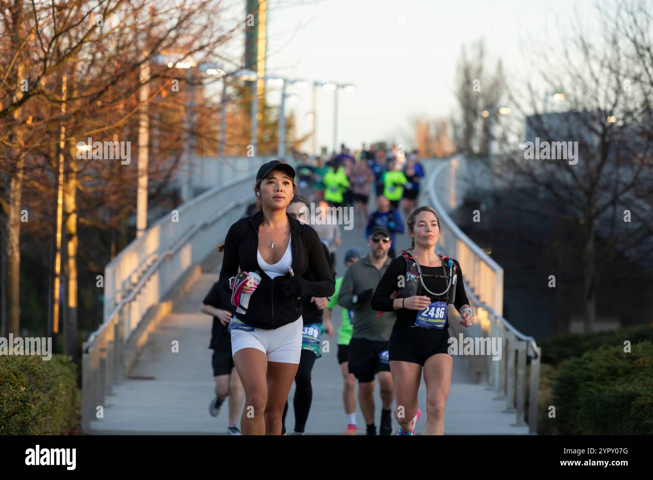 Seattle, Washington, USA. 1st December, 2024. Runners cross the ...