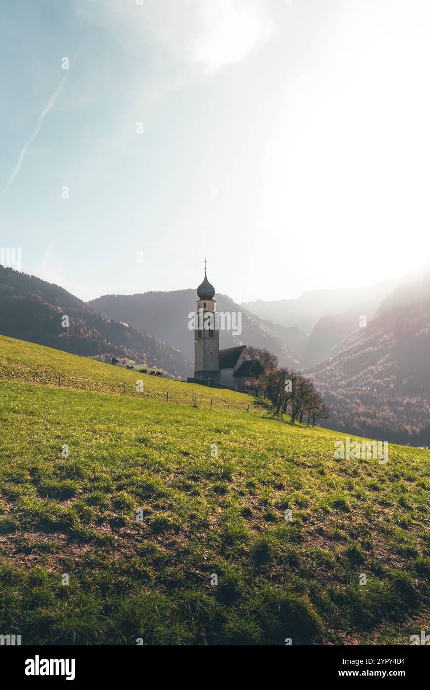 A typical church nestled in mountain meadow illuminated by a magical ...
