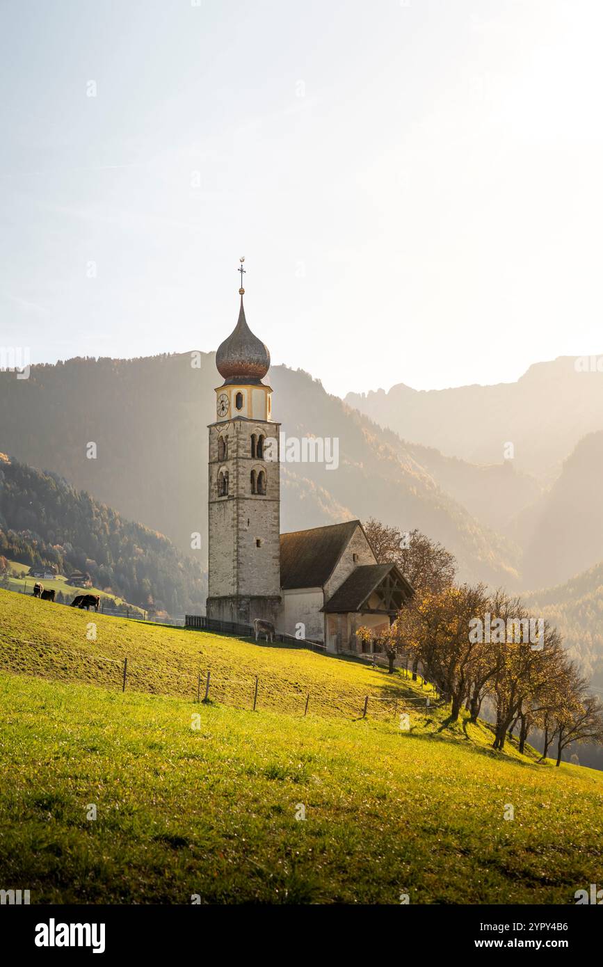 A typical church nestled in mountain meadow illuminated by a magical ...