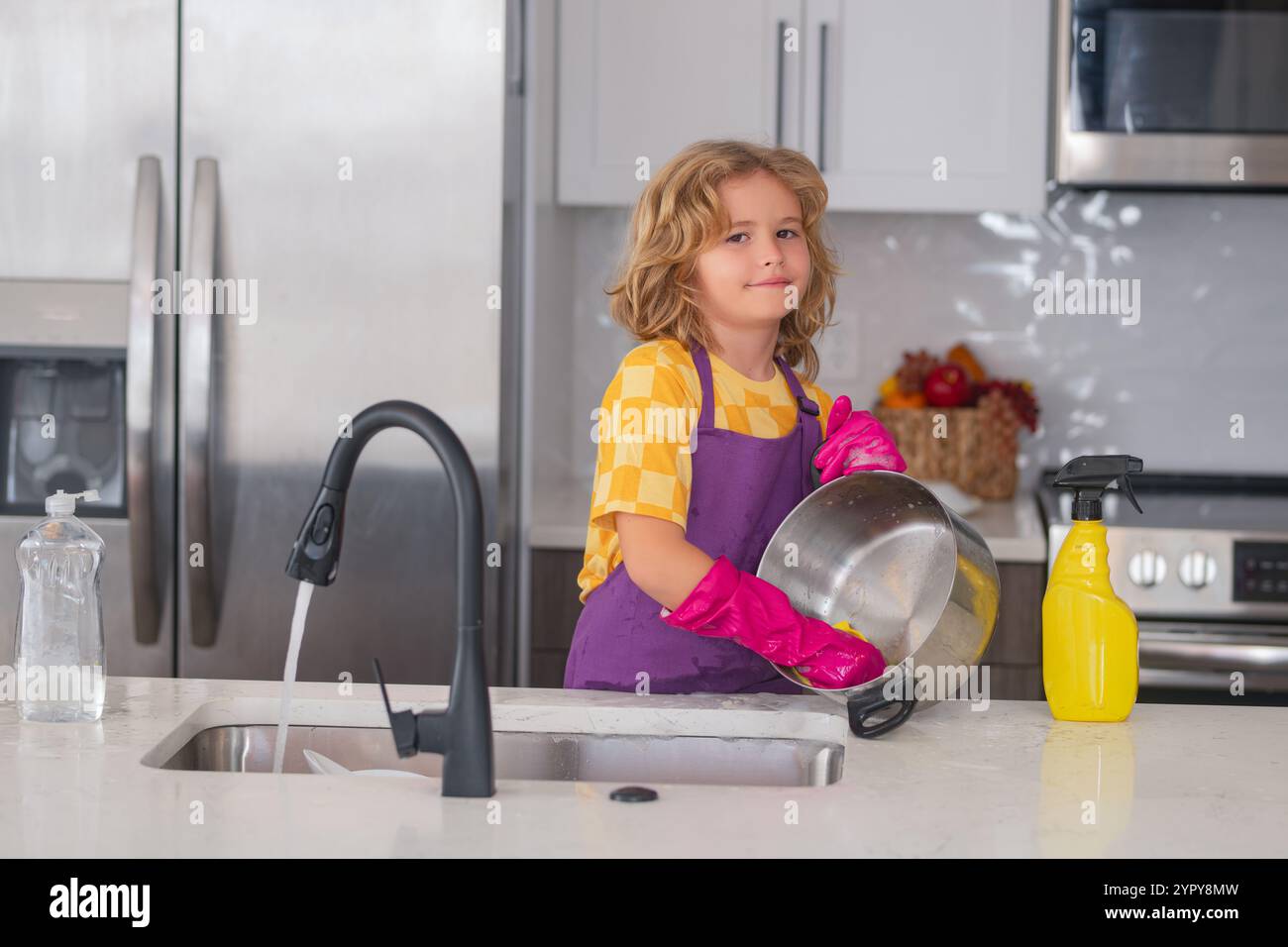 Child doing housework. Cute child helping with household, wiping dishes ...