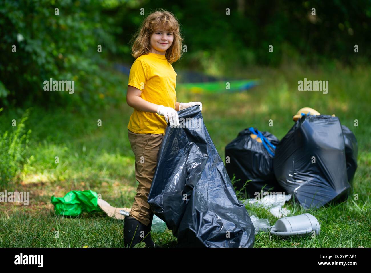 Child collecting trash outside. Ecology concept. Environmental ...