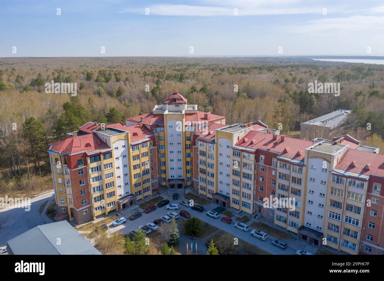 Aerial view of a multi-storey house on the edge of an endless forest to ...