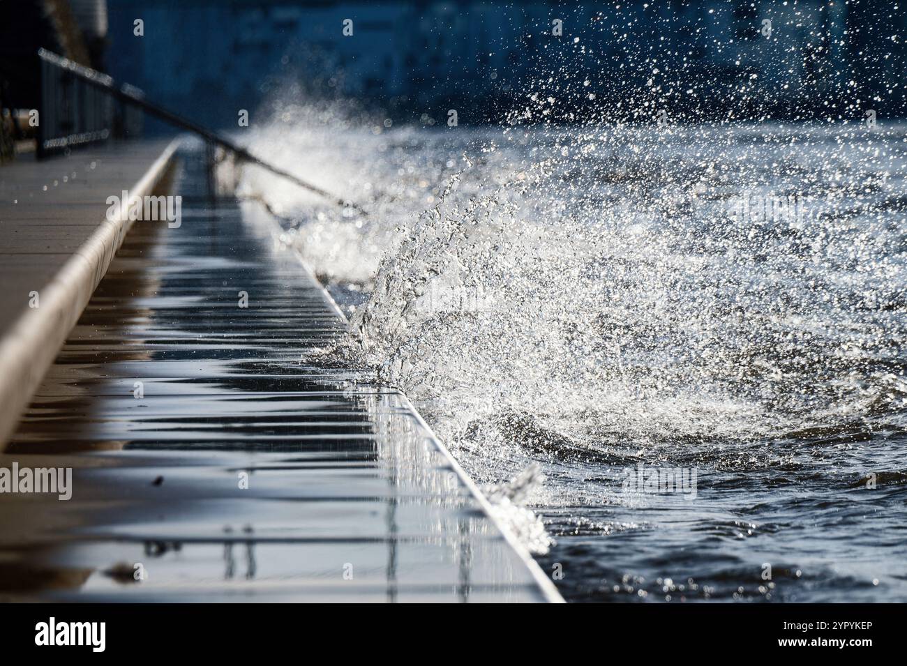 Water from waves splashes over Cologne's Rhine boulevard during high ...