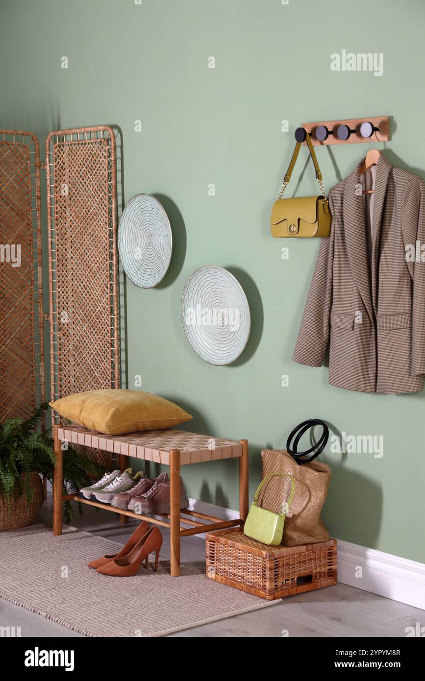 Stylish hallway interior with bench and folding screen Stock Photo - Alamy