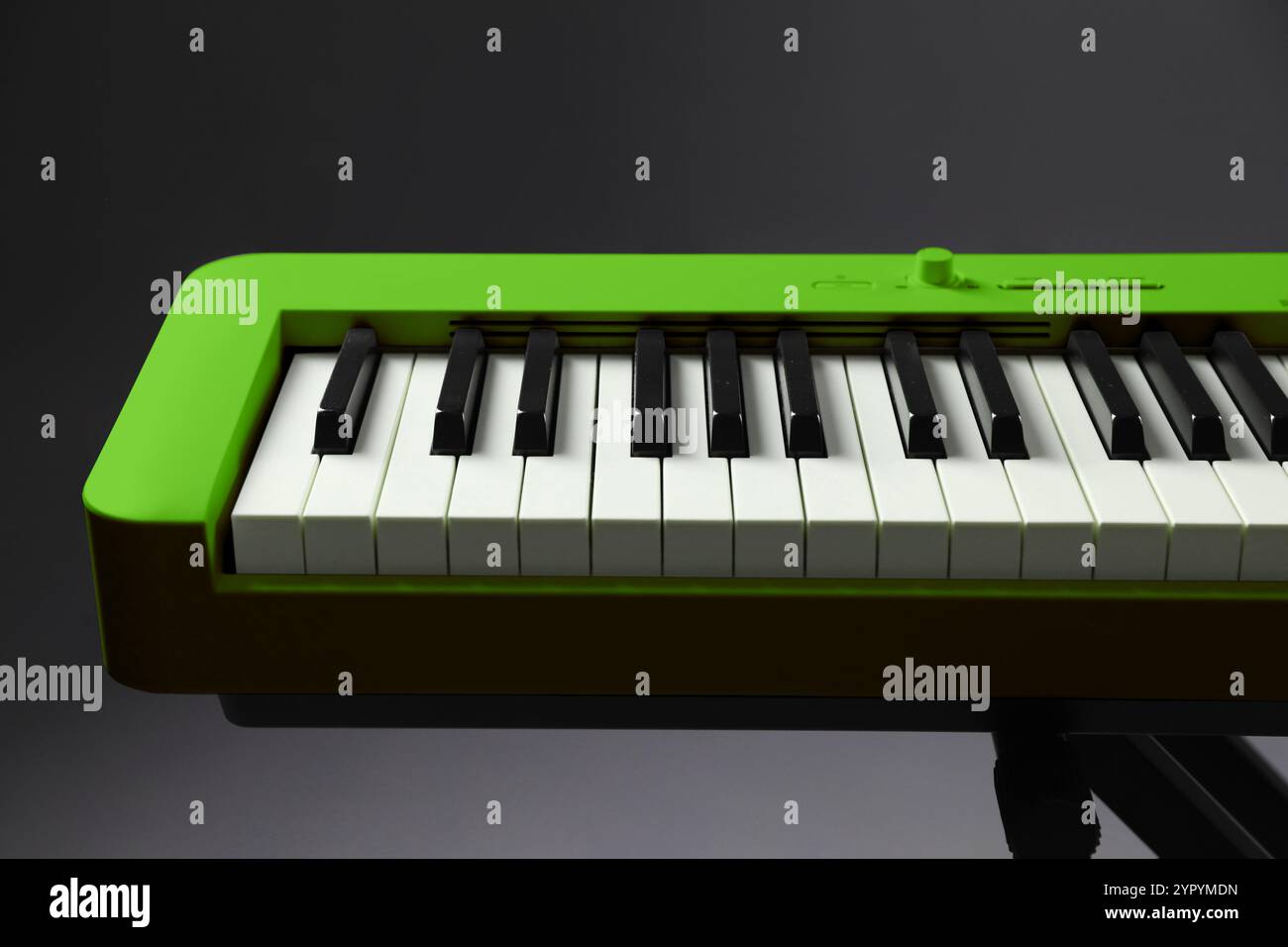 Green synthesizer on dark background. Electronic musical instrument ...