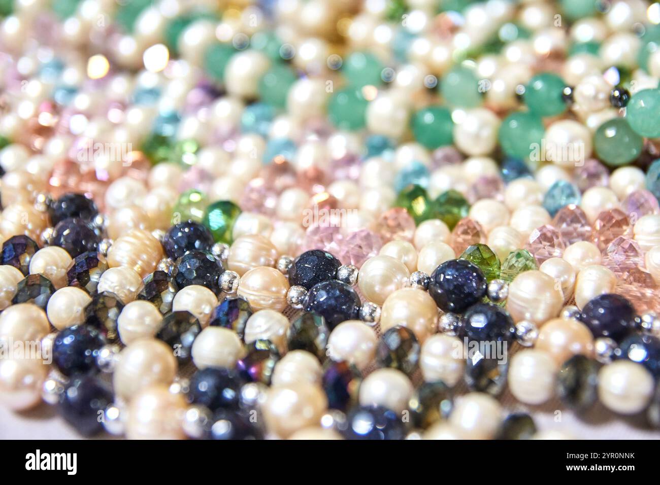 Colorful display of gemstone and pearl beads in varied shapes and sizes ...