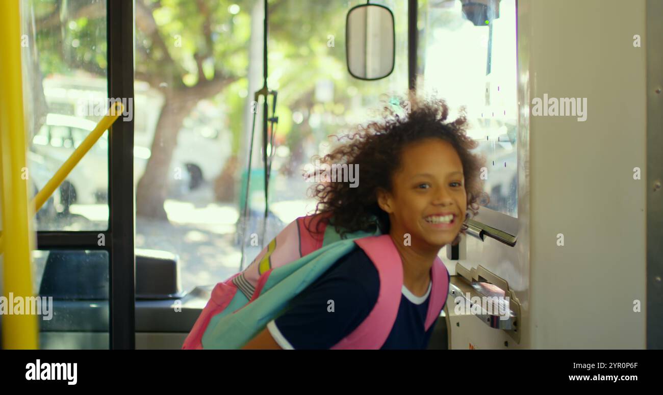 Happy girl taking ticket while travelling in bus Stock Photo - Alamy