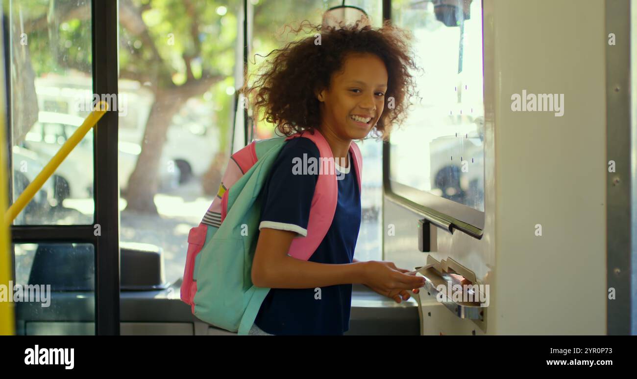 Happy girl taking ticket while travelling in bus Stock Photo - Alamy