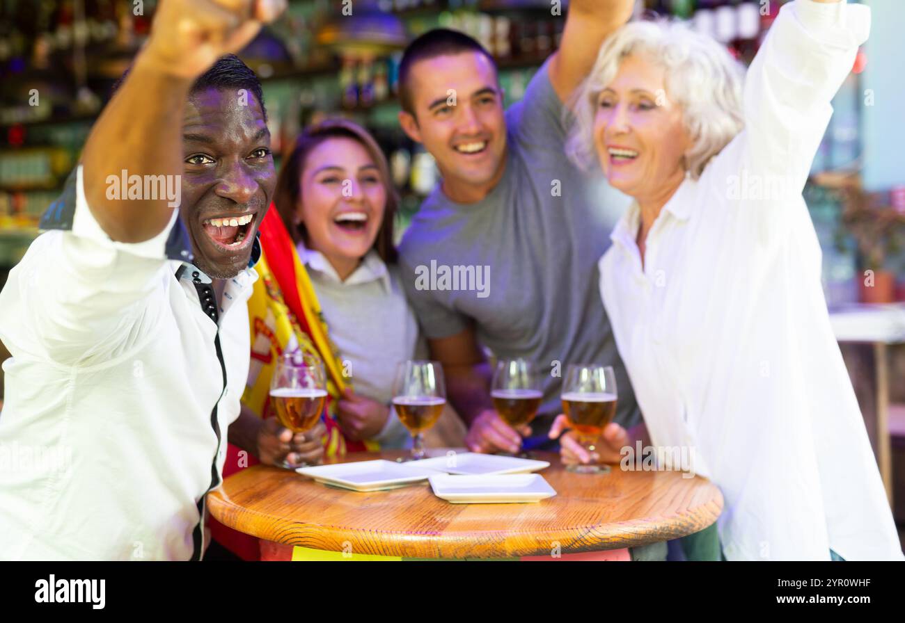 Happy fans celebrating the victory of Spanish team in bar Stock Photo ...