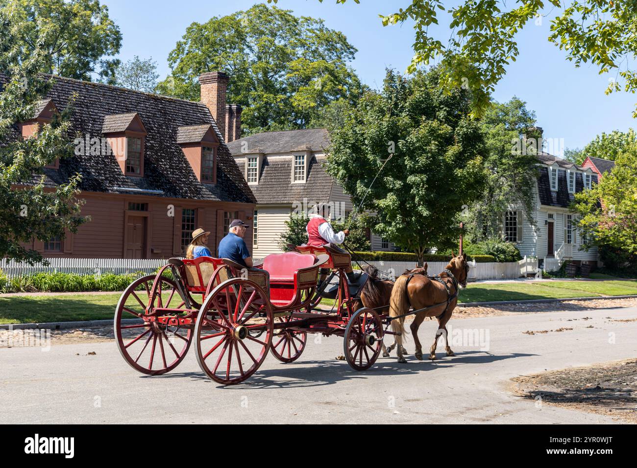 WILLIAMSBURG, VIRGINIA - AUGUST 25, 2024: A costumed actor drives ...