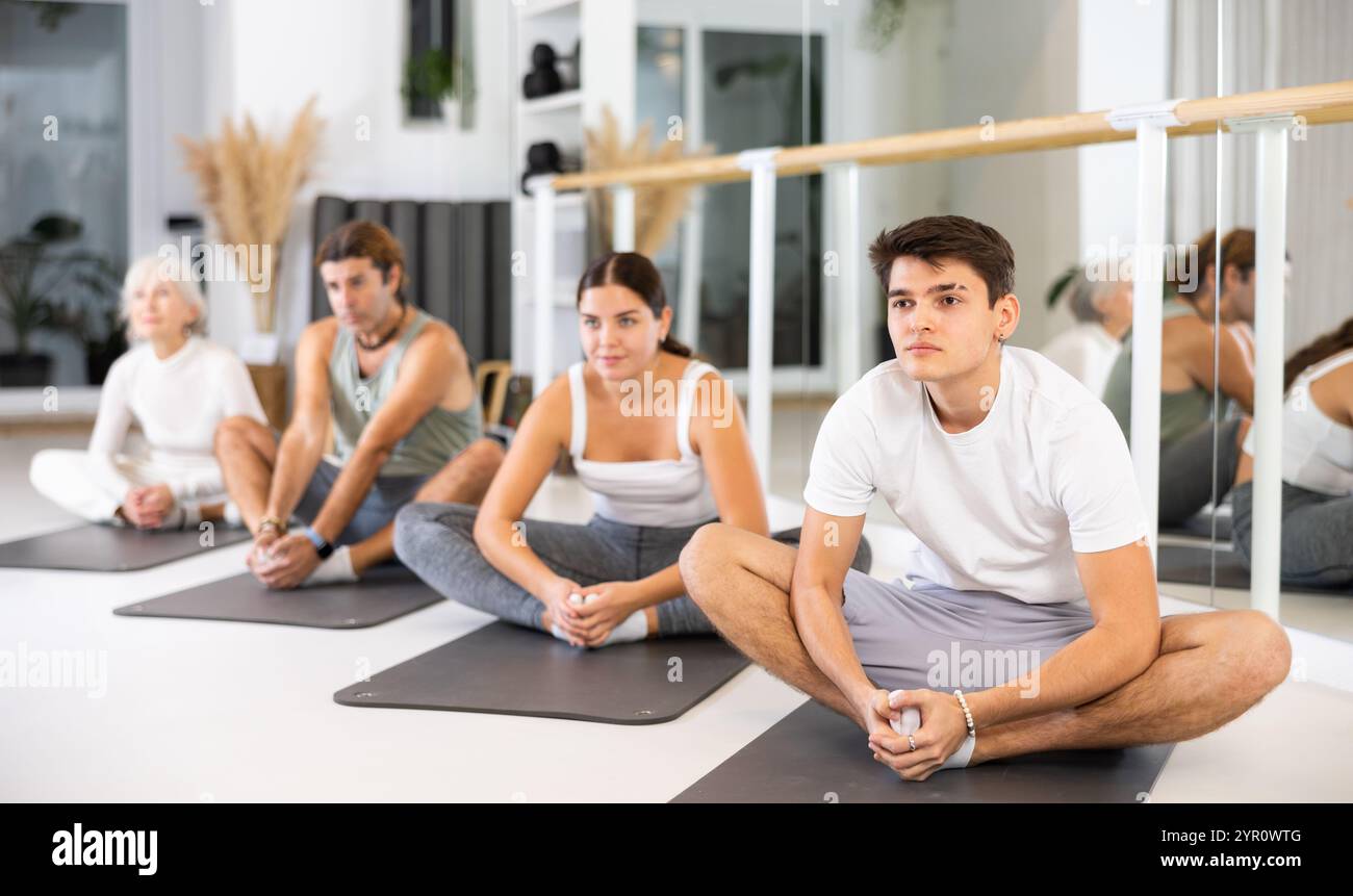 Group of different people doing exercises in gym Stock Photo - Alamy