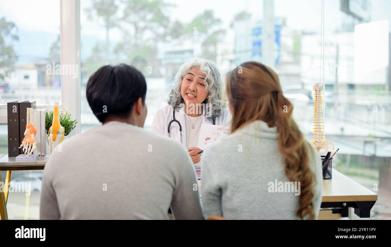 A professional senior Asian female doctor in a uniform having a ...
