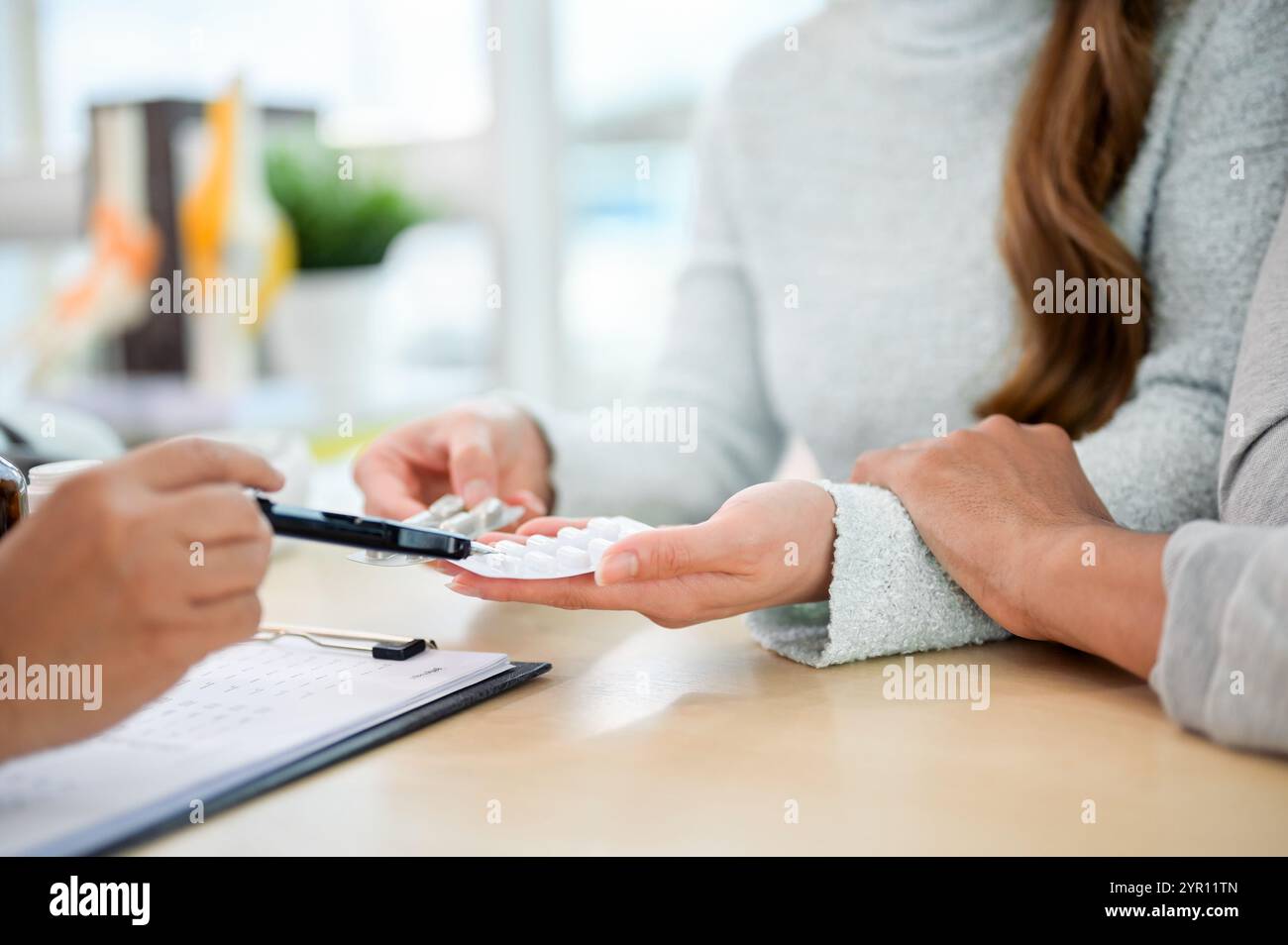 A close-up of a doctor explaining the instructions for the medication ...