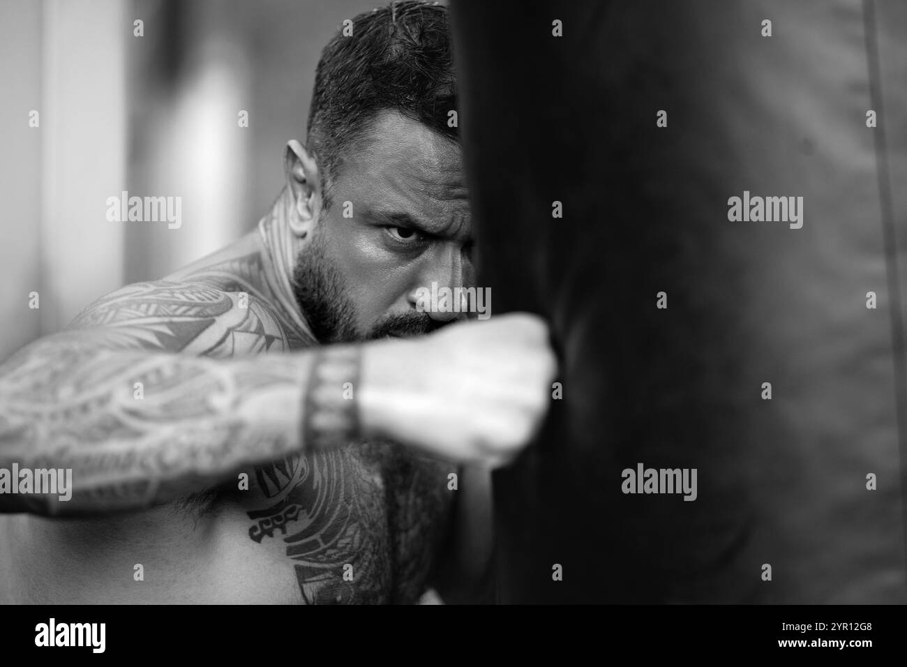 Serious danger man boxing punching bag. Man boxer face close up ...