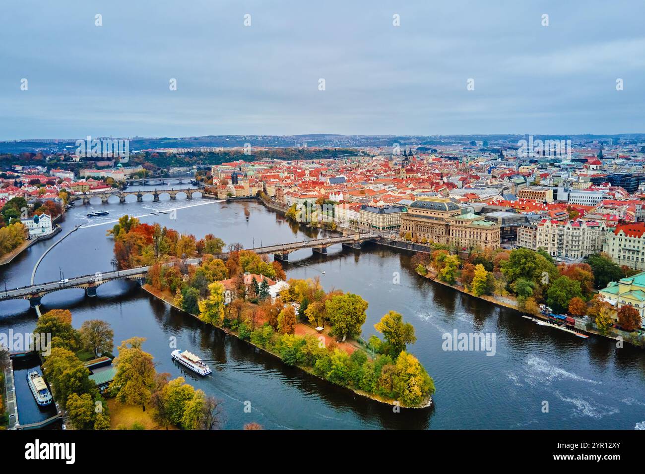 Aerial view of cityscape of Prague with colorful autumn trees on island ...