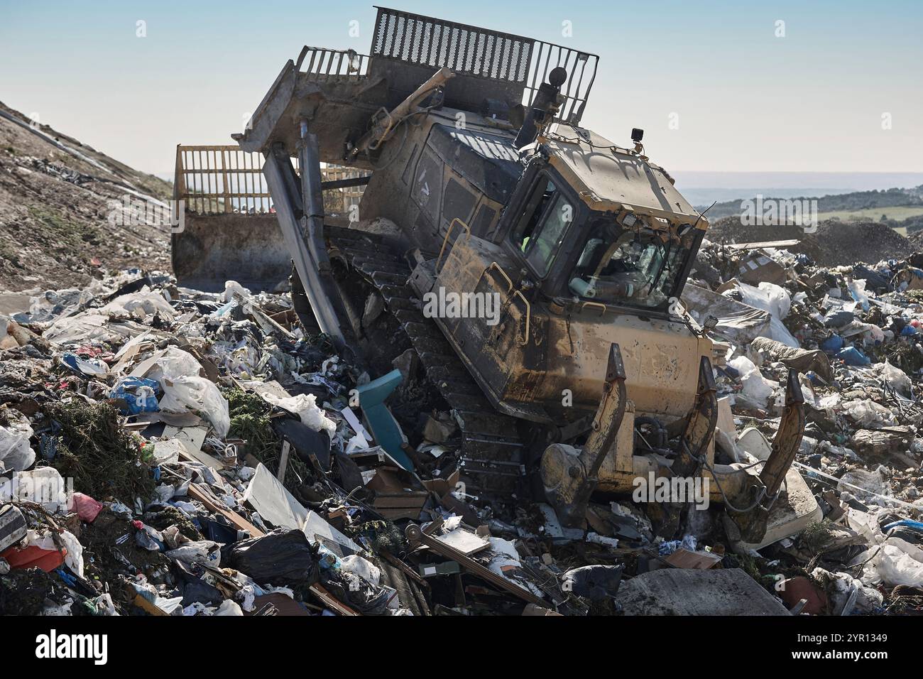 Heavy machinery shredding garbage in an open air landfill. Waste Stock ...