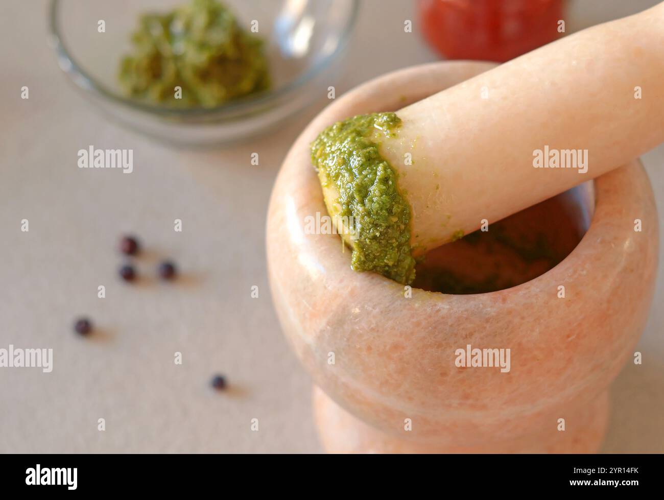 Marble mortar with pesto sauce on kitchen table. Top view. Cooking ...