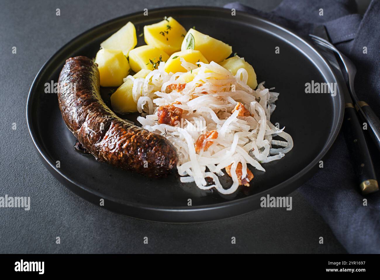 Bloody sausage morcilla, stewed sour turnip and potato close up ...